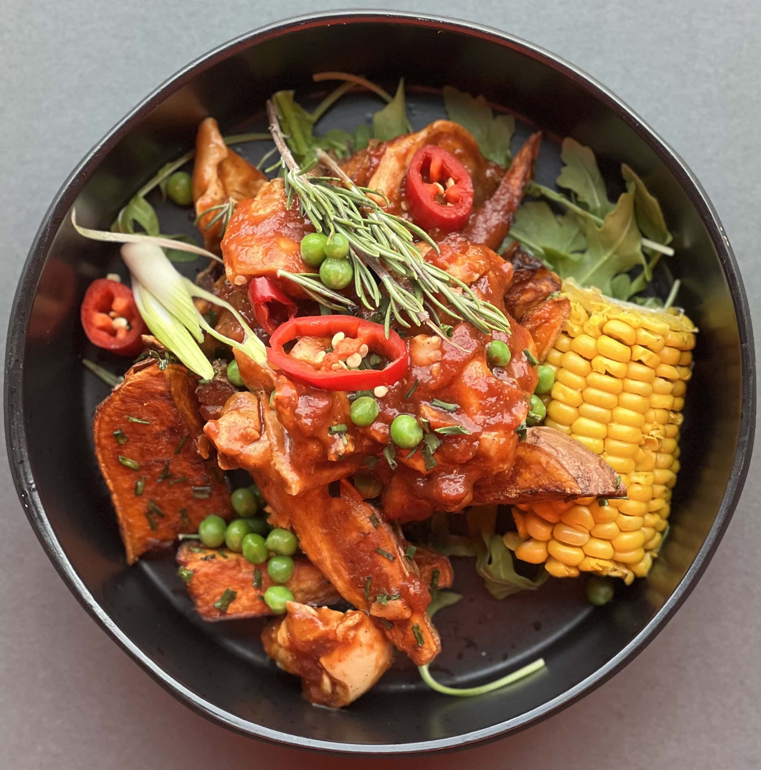 Jerk Chicken, Seasoned Sweet Potato Wedges And Peas Served With A Corn ...